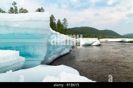 Turquoise layered ice on the river in South Yakutia, Russia Stock Photo ...