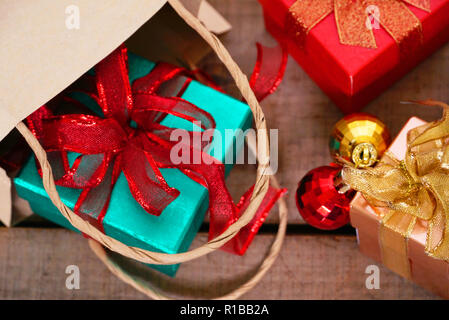 Gift boxes spill out from bag on the black background for shopping ...