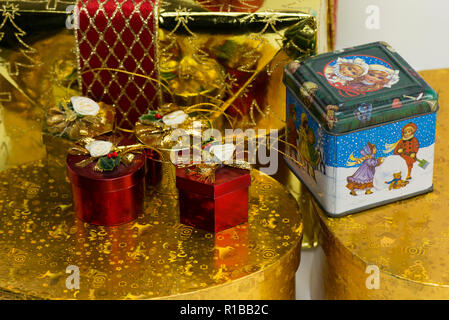 A Christmas tin, decorations, and presents Stock Photo - Alamy