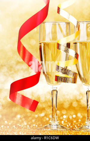 Glasses of champagne and red ribbons on golden background Stock Photo ...