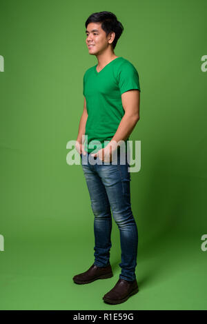 Young handsome Filipino man against green background Stock Photo - Alamy