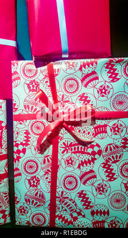 Different size and color gift boxes on the pink background. Celebration ...