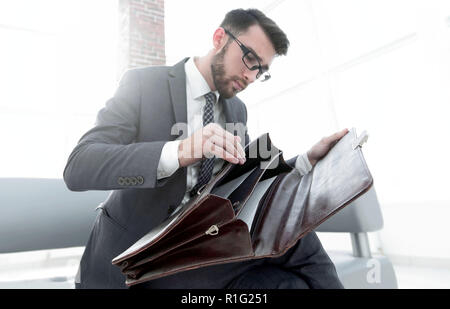 businessman's hand with suitecase in a modern office Stock Photo - Alamy