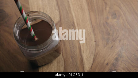 Cocoa with christmas striped paper straw on wood background with copy ...