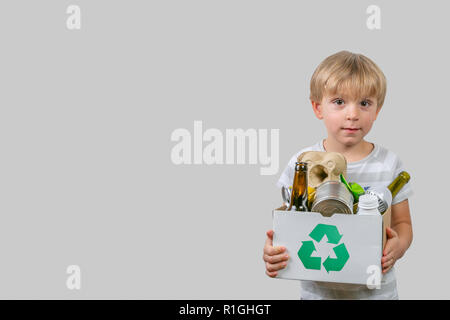Boy holds box with recyclable materials Stock Photo - Alamy