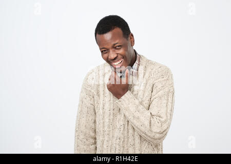 Handsome african man laughing out loud at funny meme or joke he found ...