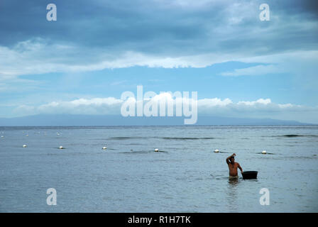 Man fishing in sea, Escano Beach, Dumaguete, Negros Oriental ...