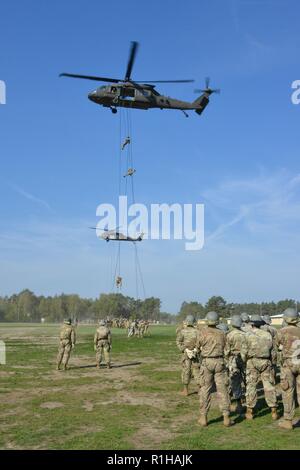 U.S. Soldiers rappel from UH-60M Black Hawk helicopters during an air ...