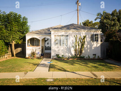 Suburban small bungalow house with single garage Stock Photo - Alamy