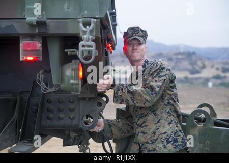 U.S. Marine Corps Cpl. Nathaniel A. Tiatia stands as a road guard ...