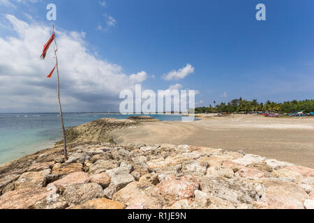 Flag on the pier at Kuta beach on Bali, Indonesia Stock Photo - Alamy