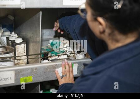 U.S. Navy Seaman organizes hazardous materials receipts aboard the ...