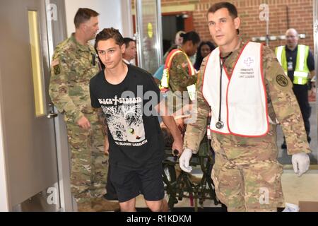 Capt. Ilya Latyshenko, a Womack emergency room doctor, assess a patient ...
