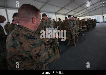 U.S. Navy Lt. Cmdr. Mike Trumbull, center, a flight officer attached ...