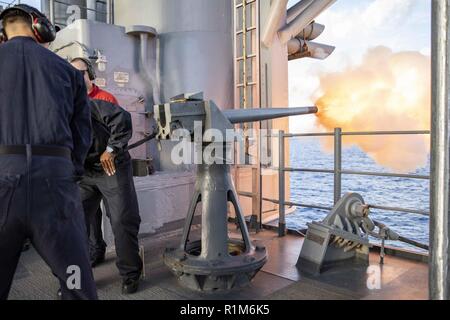 Sailors fire a 40mm saluting battery aboard the amphibious assault ship ...
