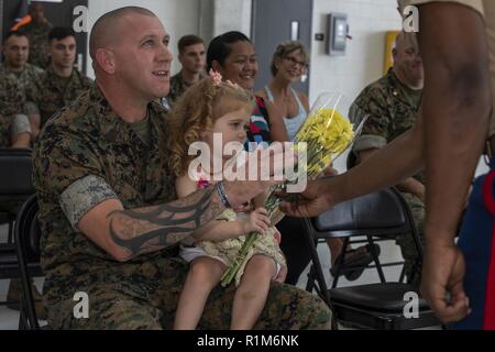 Flowers are presented to U.S. Marine Corps Lt. Col. Anthony D. Ramey’s ...