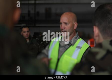 Staff Sgt. Andrew Marsala instructs the proper fit of the JLIST suit ...