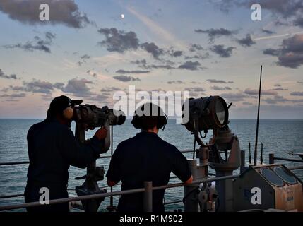 US Navy Sailors scan the horizon for surface contacts while on watch ...