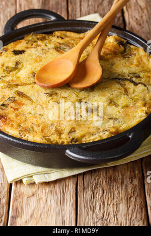 Frying pan with tasty mashed potatoes and mushrooms on light wooden ...