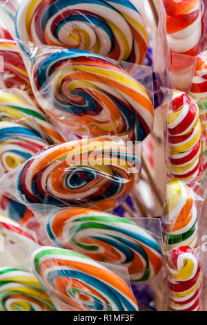 Many sweet lollipops arranged in rows on yellow background Stock Photo ...
