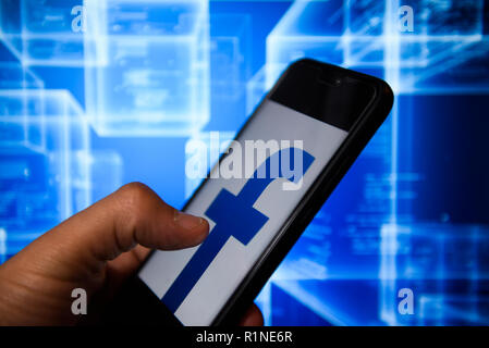 Facebook logo is seen on an Android mobile device with USA flag on the ...