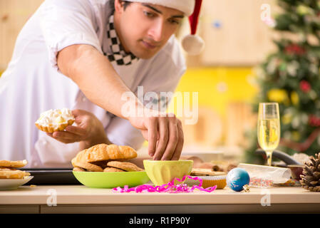Young chef husband working in kitchen at Christmas eve Stock Photo - Alamy