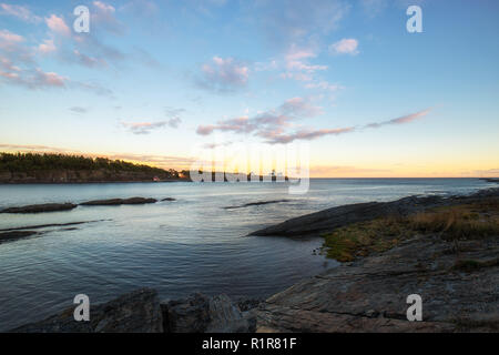 The wild coast of Norway at a sunset. The Fjord of Langesund with the ...
