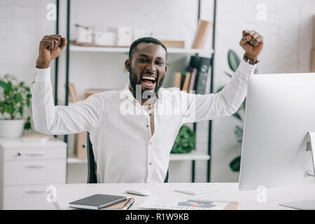 excited handsome businessman screaming and showing yes gesture in ...