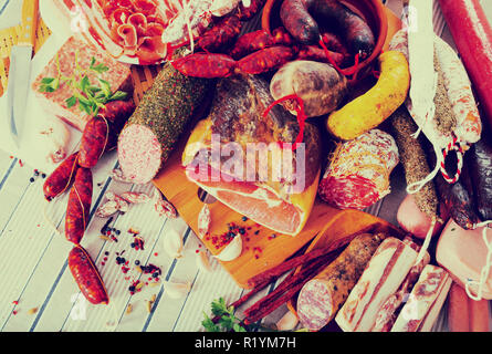 Variety of meats, sausages and mince with herbs on table Stock Photo ...