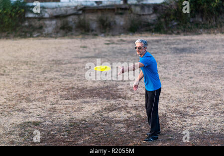 Senior man playing frisbee in the park outdoors Stock Photo - Alamy