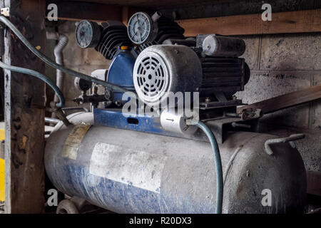 Air compressor with a receiver. Equipment under the workbench Stock ...
