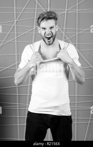 Fashion man pull tshirt collar with anger. Fashion model in casual ...