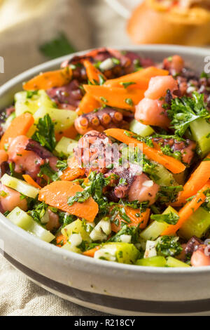 Seafood appetizer. Octopus salad on white plate. Mediterranean delicacy ...