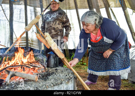 Cree people cooking wild bannock and geese in a teepee in Northern ...