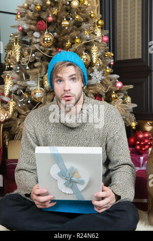surprised man in sweater and santa claus hat. xmas guy pointing finger ...
