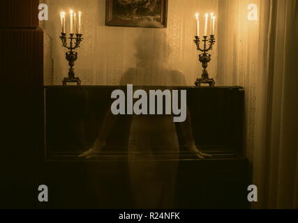 Ghost woman in room with candles Stock Photo - Alamy