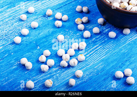 spilled many chickpeas on a blue wooden background Stock Photo - Alamy