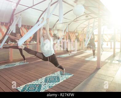 girls fly in class on the fly yoga Stock Photo - Alamy