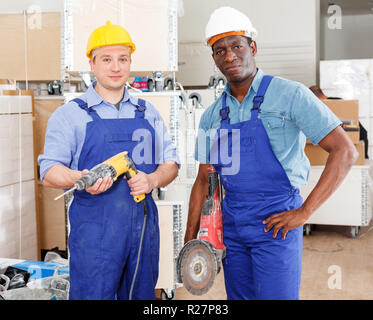 Builders using manual power tools Stock Photo - Alamy