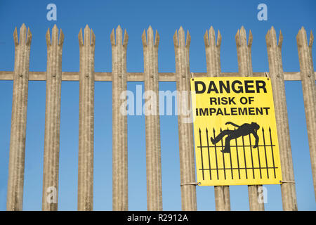 Impalement danger and risk sign on fence for security and protection ...