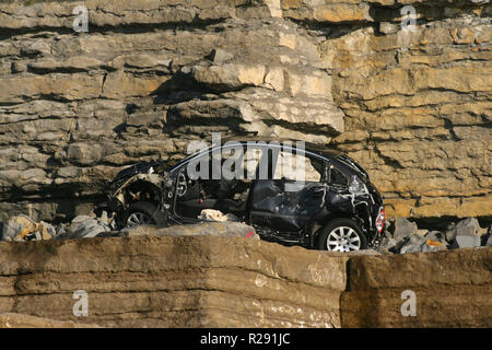A crashed car, a black Volkswagen Polo, in a country lane surrounded by ...