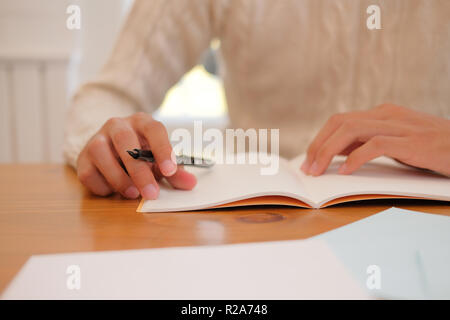 man wearing cream sweater writing christmas letter greeting card ...