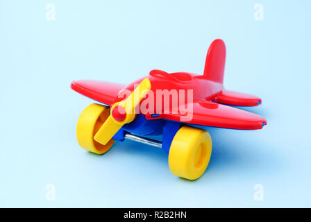 Toy children's red plane on a blue background, top view Stock Photo - Alamy
