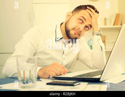 Stressed man worker facing challenge in project in office Stock Photo ...