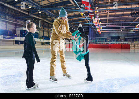 Coach Teaching Girl Figure Skating Stock Photo - Alamy