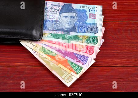 Pakistani Rupee in the black wallet Stock Photo - Alamy