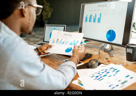 Coworkers working with analitycs sitting together at the working place ...