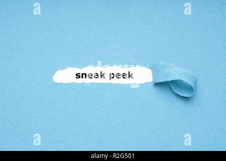 sneak peek text revealed by peeling off torn blue paper background ...