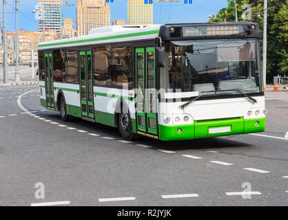 white city bus goes along street Stock Photo - Alamy