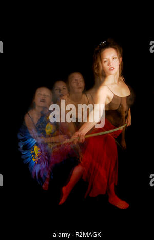 Long exposure photo with dancing girls dressed in led light costumes ...